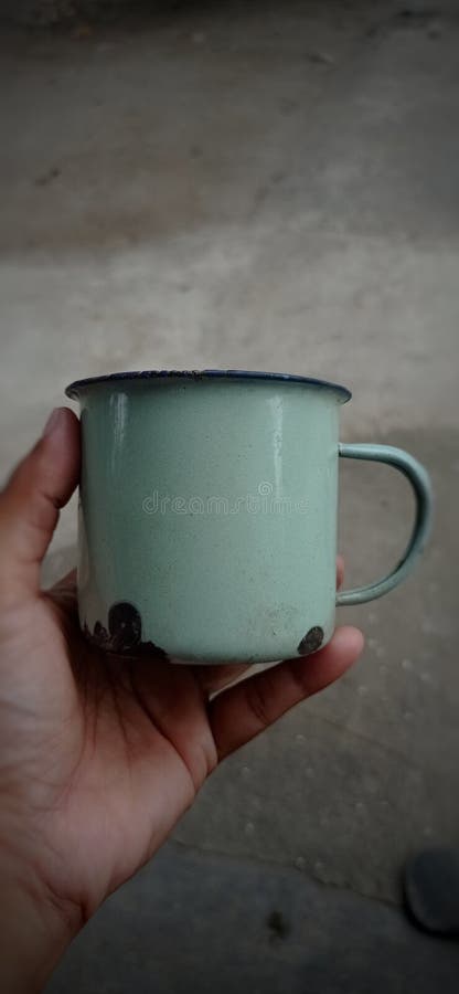A Zinc Enamel Cup or Green Mug in Hand Stock Photo - Image of zinc ...