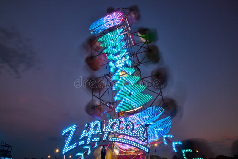 Zipper Carnival Ride with Blurred Lights during Dusk at County Fair ...