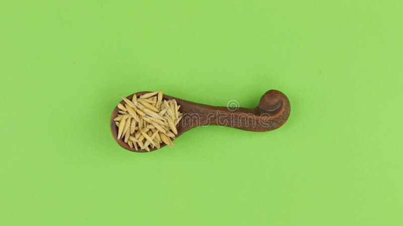 Zoom of a Clay Spoon with Oat Grain. Chroma Key, Green Screen Stock ...