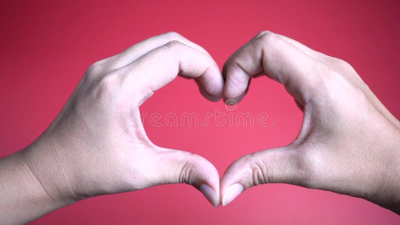 Zoom in Hands Making Heart Shape on Red Background. Stock Video - Video ...