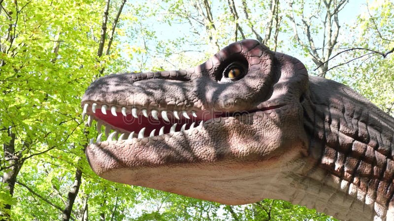 Zoom-in Image of the Head of a Scary Dinosaur with Big Teeth Against a ...