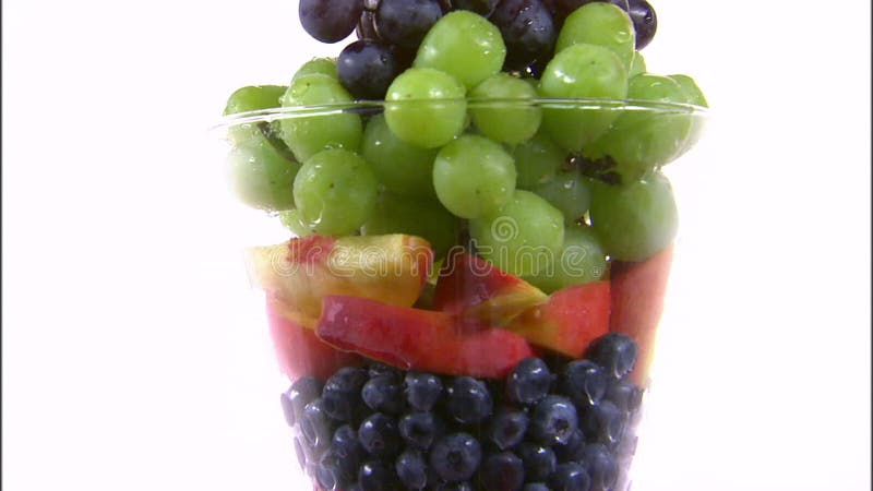 Zoom Out of Fruit Assortment in a Vase Rotating on White Background ...