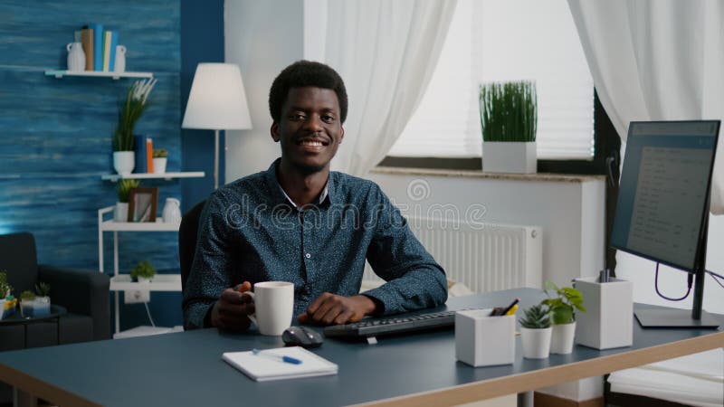 Zoom in Shot on African American Black Man Freelancer Smiling into the ... Zoom in Shot on African American Black Man Freelancer Smiling into the ...