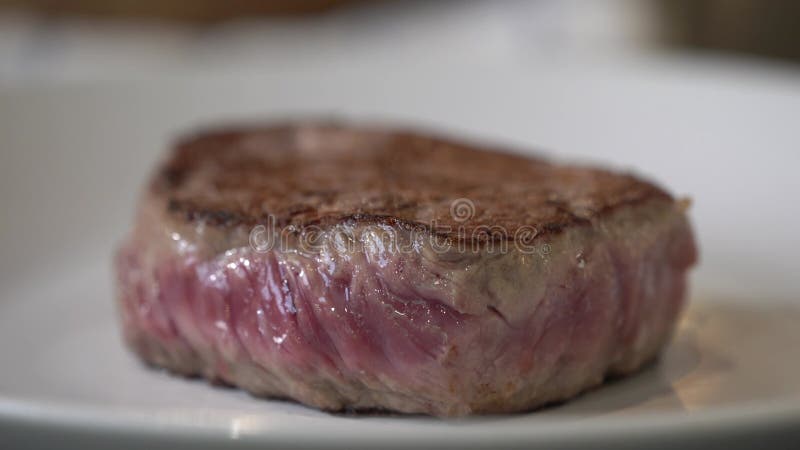 Zoomed-in Medium-Cooked Beef Steak on White Plate Stock Footage - Video ...