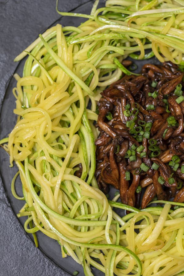 Zucchini Spaghetti with Shimeji on Black Stone Plate Stock Photo ...