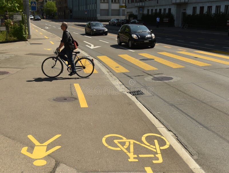 Zurich, Switzerland - June 03, 2017: Bicyclist on Street of Zurich ... Zurich, Switzerland - June 03, 2017: Bicyclist on Street of Zurich ...