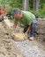 Man building stone wall stock image. Image of garden - 17735239