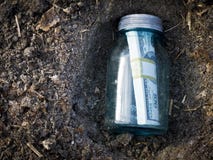 Man Burying Jar of Money stock photo. Image of concept - 38237874