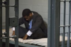 Man Sitting On Bed In Prison Cell Stock Photo - Image of imprisoned ...