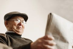 Grandpa reading newspaper stock image. Image of people - 22860895