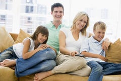 Family Sitting In Living Room With Remote Control Royalty Free Stock ...