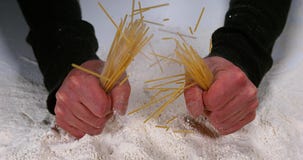 Hands Of Man Breaking Spaghetti Pasta Against Flour Background, Stock ...