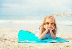 Little Girl Sunbathing On The Beach Stock Photo - Image of knee, face ...