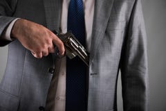 Man Pulling Gun Out Of Pocket Stock Photo - Image of horizontal ...