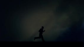Man Running Under Storm Lightning Loop Stock Video Footage by Megapixl