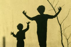 Kids shadows stock photo. Image of having, shadow, grass - 5677622