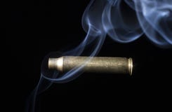 Smoking Rifle Cartridge On Black Stock Photo - Image of metal, grey ...