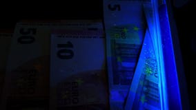 Checking Bills With Uv Light. Dollars Under Ultraviolet. Stock Video ...