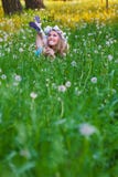 Young Woman Lying On The Field In Green Grass And Blowing Dandelion ...