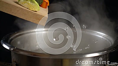 Adding a Vegetables To Boiling Water in Pan, Slow Motion Stock Video ...