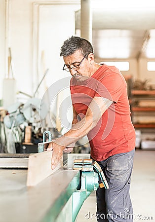 Adult Man Focused Working Manually With A Wood Planing Machine Stock ...