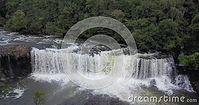 Aerial Shot of a Wide Waterfall with Thick Vegetation on the Side Stock ...