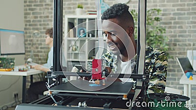 African American Guy Using 3d Printer in Office Enjoying Modern ...