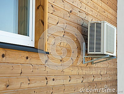 Air Conditioner Condenser On The Wooden Wall Of Boards. Royalty-Free ...