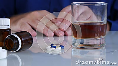 Alcoholic Person in Front of Alcohol and Medical Pills with Hands ...