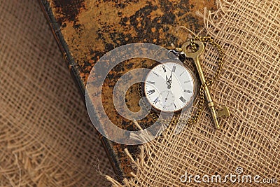 Ancient Pocket Watch And Key On Old Folio Half-covered With Old ...