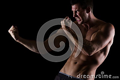 Angry Muscular Man In Attack Pose On Black Stock Photography - Image ...