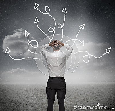 Anxious Businessman Looking At Jumbled Arrows Stock Photo - Image: 32510340