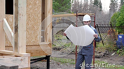 Caucasian Worker in Front of a House. Architects or Builder Check Plans ...