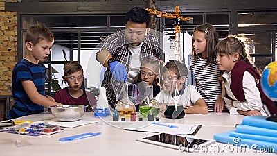 Asian Science Teacher with Kids in Lab Class Working about Experiment ...