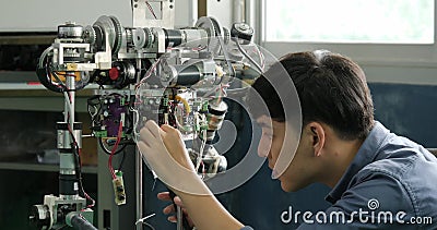 Young Electronics Engineer Team Collaborating on Construction of Robot ...