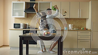 Attractive Young Joyful Couple Have Fun Dancing and Singing while ...