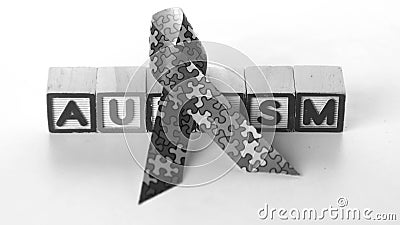 Awareness Ribbon Falling in Front of Autism Letter Blocks in Black and ...