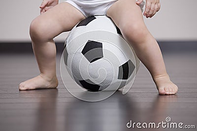 Baby Sitting On Soccer Ball Royalty Free Stock Photos - Image: 33832818