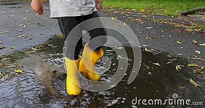Baby Stomping through Puddles in Yellow Rubber Boots Stock Footage ...