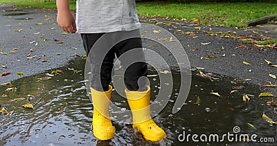 Baby Stomping through Puddles in Yellow Rubber Boots Stock Footage ...