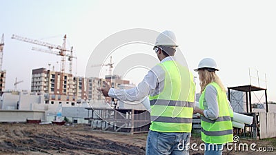 Back Turned Engineer and Controller at Construction Site Reviewing ...