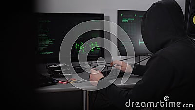 Back View Of A Hooded Hacker Making Cyber Attack On Bank Network. Man ...