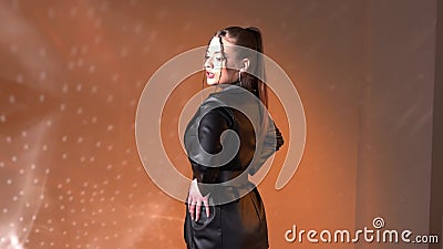 Back View of Model in Black Costume at Studio Orange Neon Lights on ...