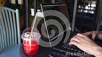 Back View Over the Shoulder Shot of Developer Programmer with Laptop. Program Code and Script ...