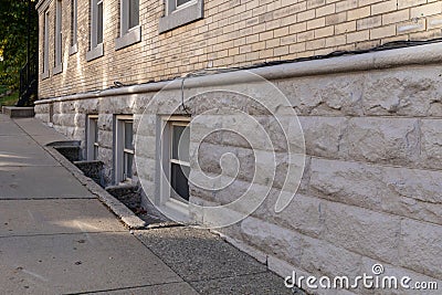 Basement Window Wells On A Building Made From Rusticated Stone And ...