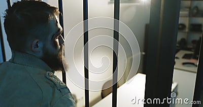 A Battered Man with a Beard Stands in the Prison Cell. Stock Video ...