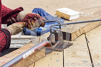 Bending Reinforcement Metal Rebar. Worker Using Bending Rebar Machine ...
