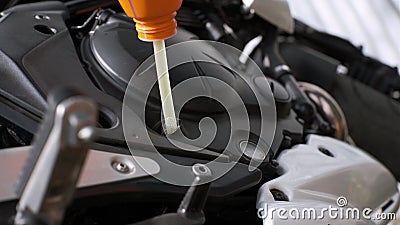 Biker Change Engine Oil on Motorcycle. Pouring Oil To Motorcycle Engine ...