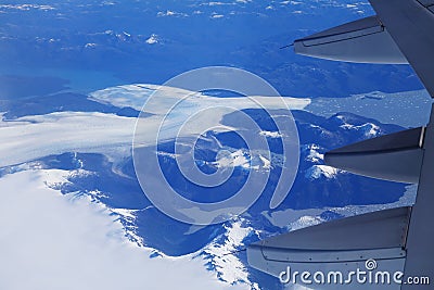 Birds eye view of Glacier under the plane wing - Stock Image - Everypixel