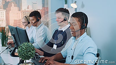 Black Customer Support Agent Working in Busy Call Center by Talking To ...